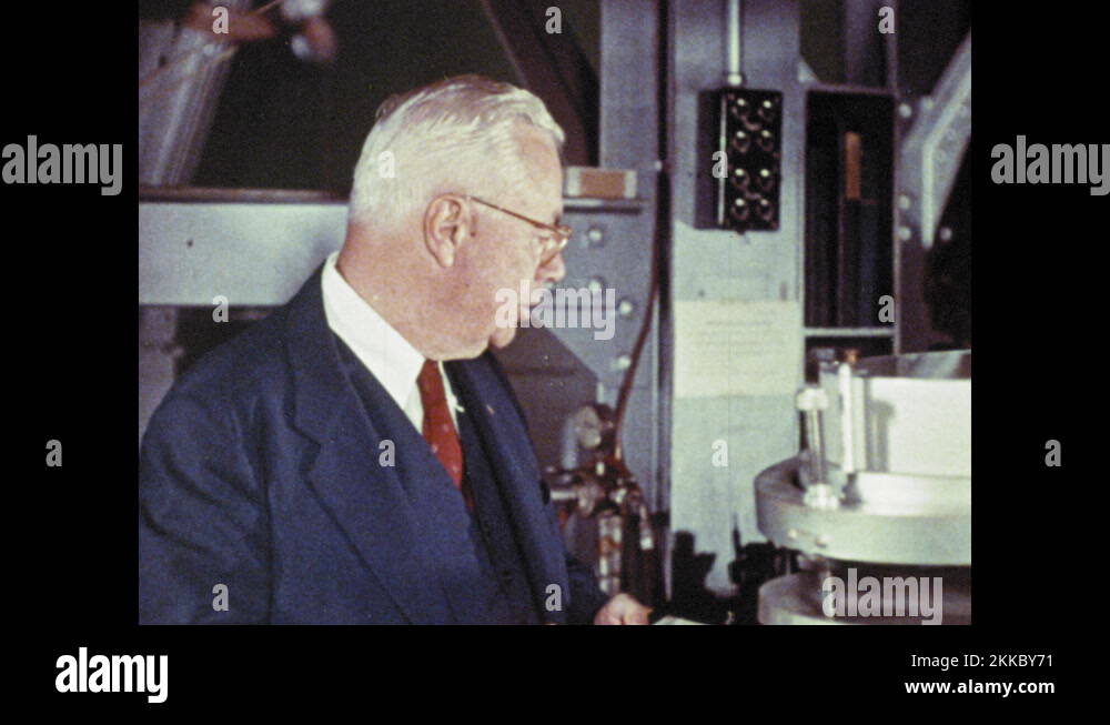1950s: Men work in observatory. Light shines in through observatory ...