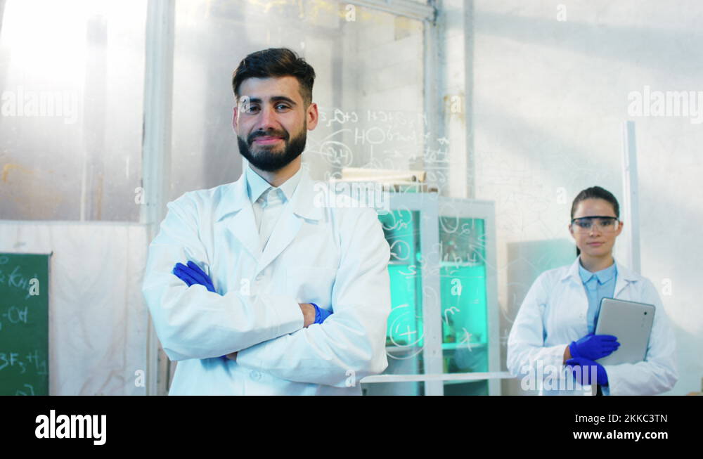Biotechnology laboratory two young scientists in the uniform posing ...