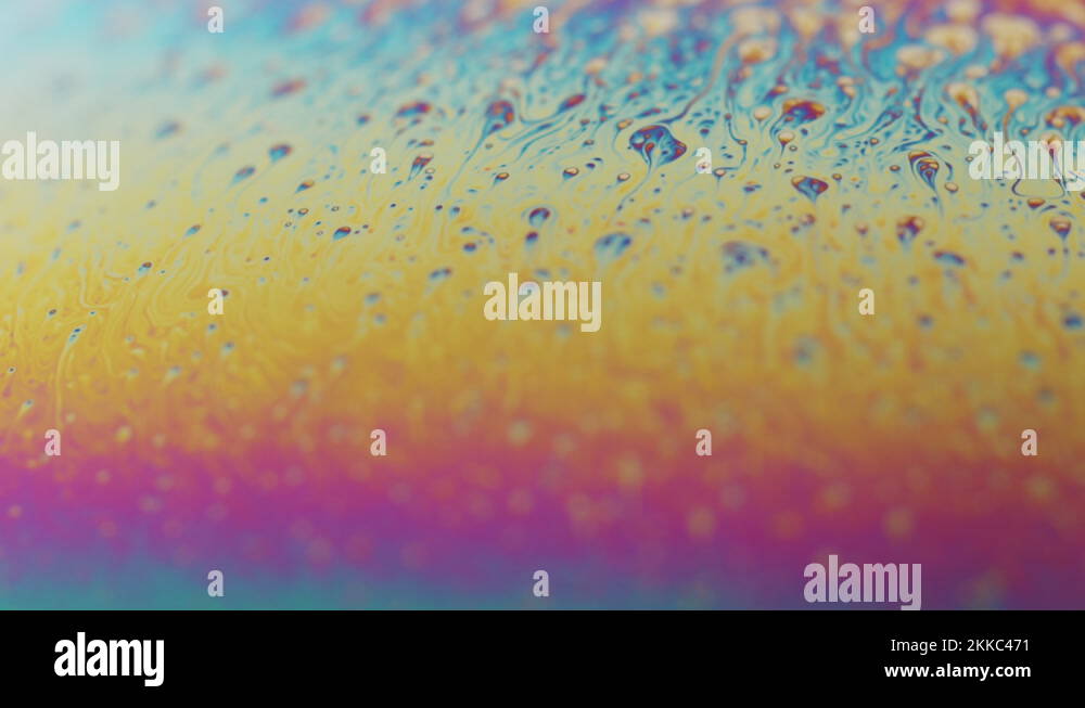 Liquid showing a colors of the rainbow and moving in slow motion ...