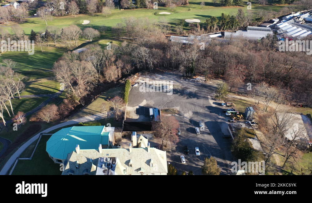 An aerial view over an upscale, luxury mansion with a golf course on ...