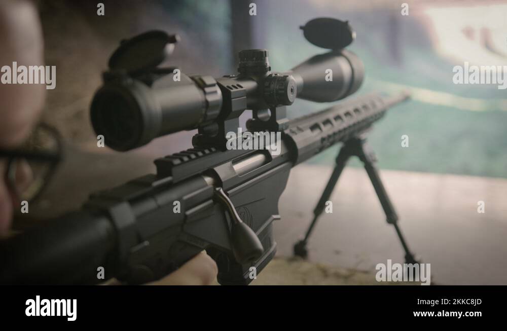 Shooter firing sniper rifle on shooting range, close up on weapon Stock ...
