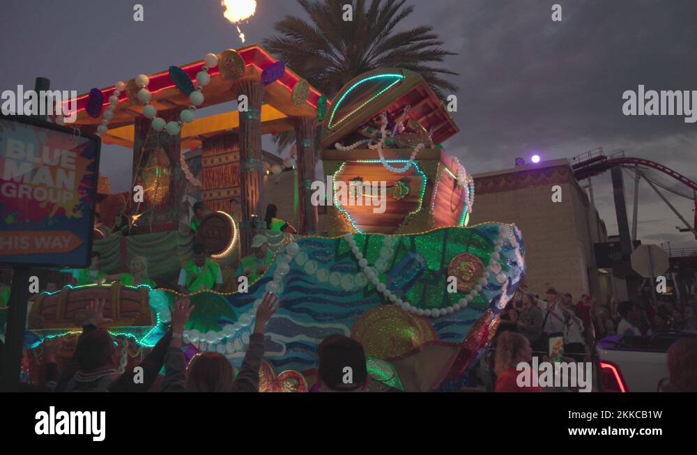 People throwing candy and necklaces from a big truck at a parade Stock ...