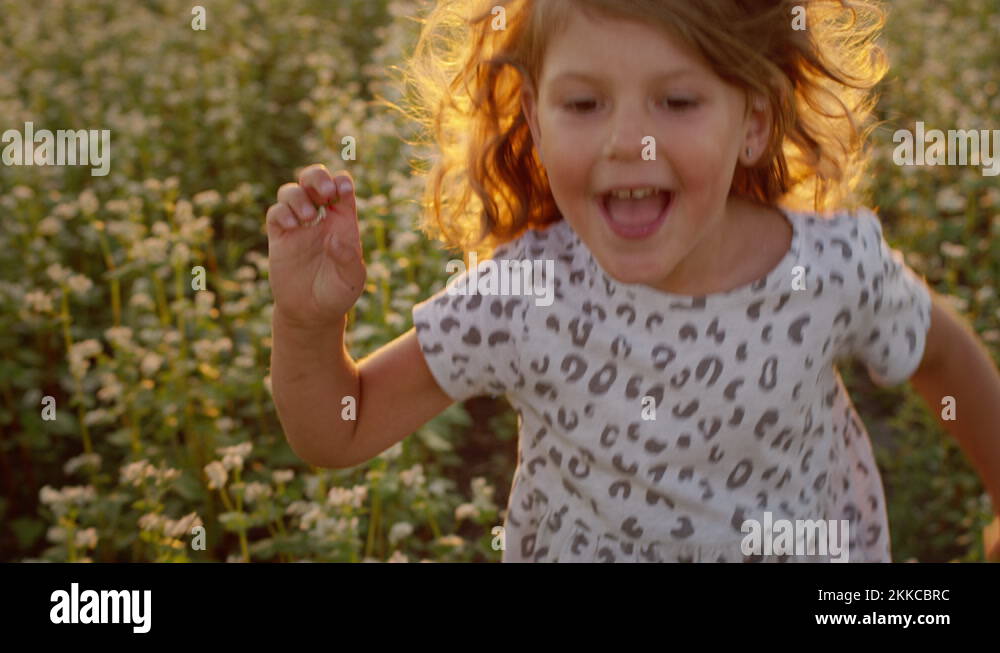 Little Girl Running Across The Field. Pretty Little Girl With Long ...