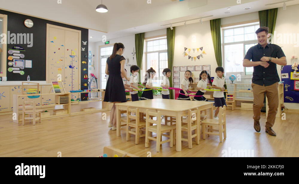 Teachers and children playing games in kindergarten classroom,4K Stock ...