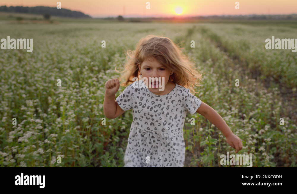 Little Girl Running Across The Field. Pretty Little Girl With Long ...