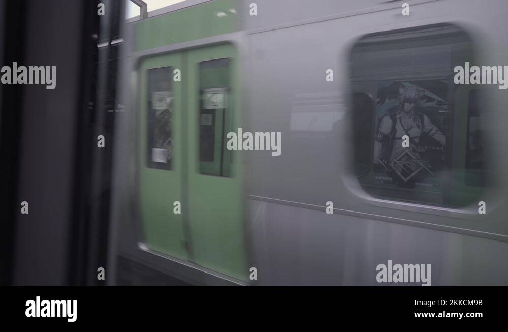 Japanese Train passing and commuter waiting at train station of Tokyo ...