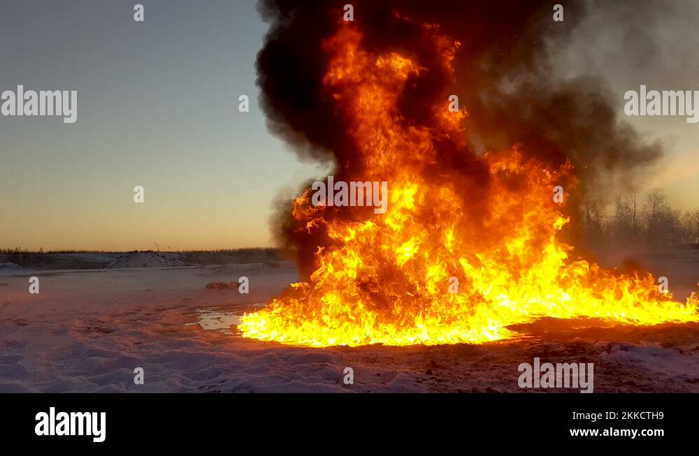 Huge cloud of black smoke billows into the sky as an oil spill burns up ...
