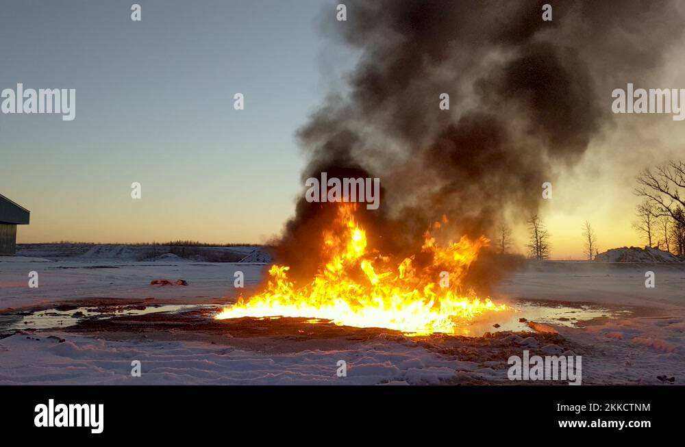 Huge fire burns up an oil spill leaving huge thick black clouds of ...