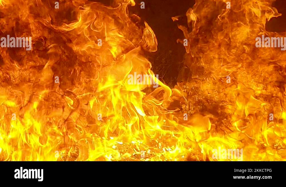 Huge blazing fire throws tons of oil thick black oil smoke into the air ...