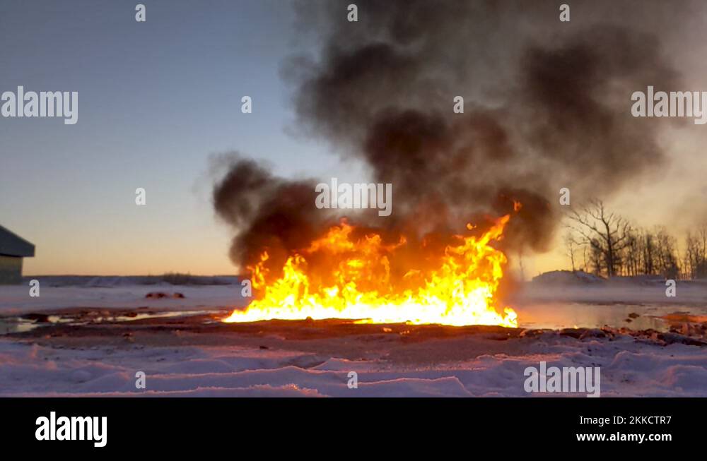 Huge flames from burning oil spill send thick dark black smoke ...