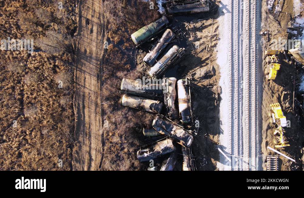 A train wreck on the railroad, scattered cisterns, tractors are ...