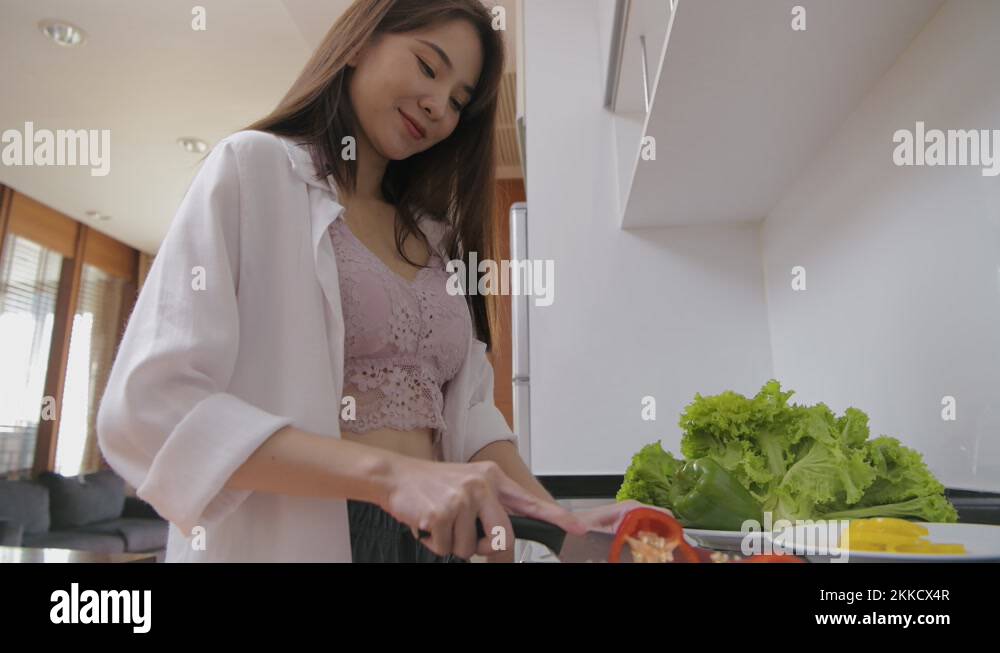 Health concept of 4k Resolution. Asian girls cutting vegetables in the ...