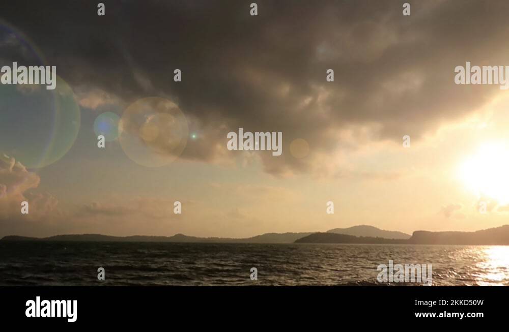 Sunrise golden gray cloud in bright sun light ray n bokeh lens flare ...