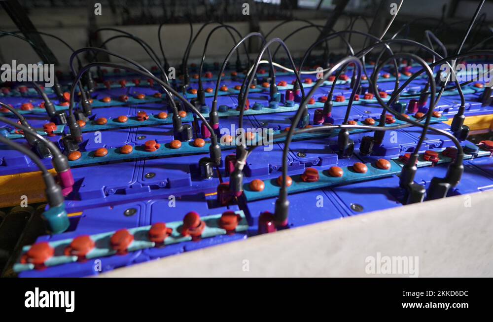 A stand for charging new batteries at the factory. Car batteries are ...