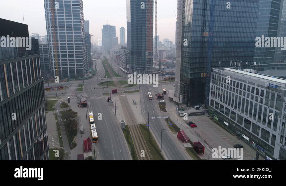 Aerial view of an empty city main street with just a city bus on a stop ...