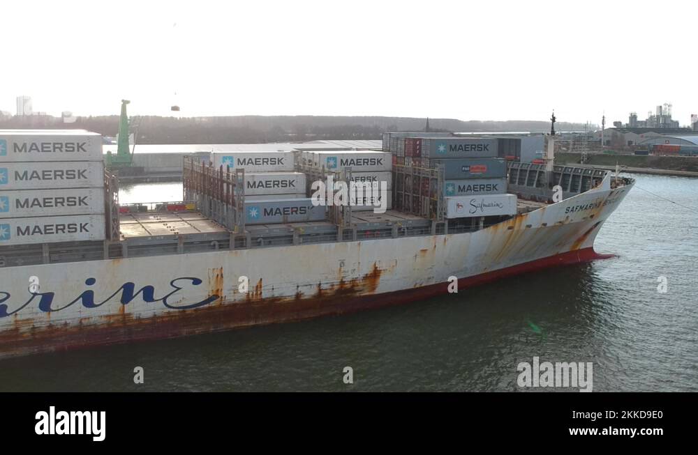 Huge old and rusty container ship leaving Antwerp harbor. Maersk Stock ...