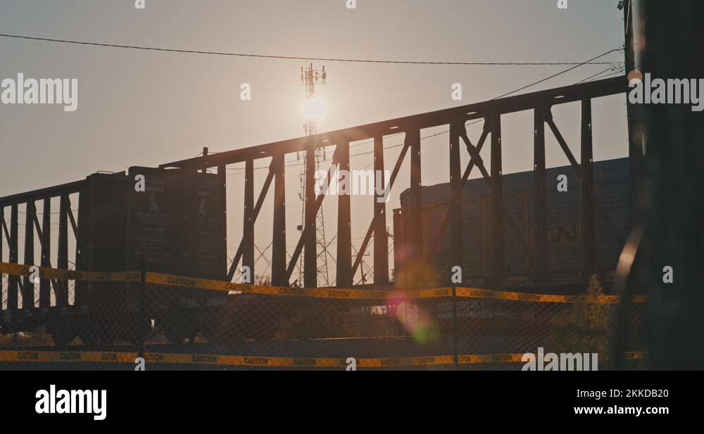 Freight Train Cargo Coming to a Stop During Golden Hour with Sun Flares ...