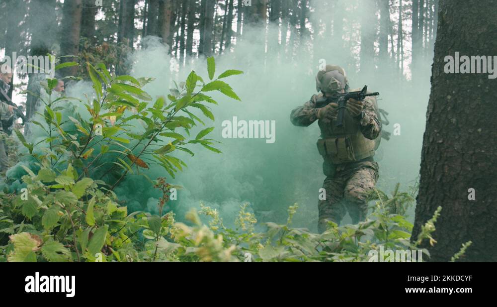 Soldiers running millitary action in dense forest with smoke in backgorund, army Stock Video ...