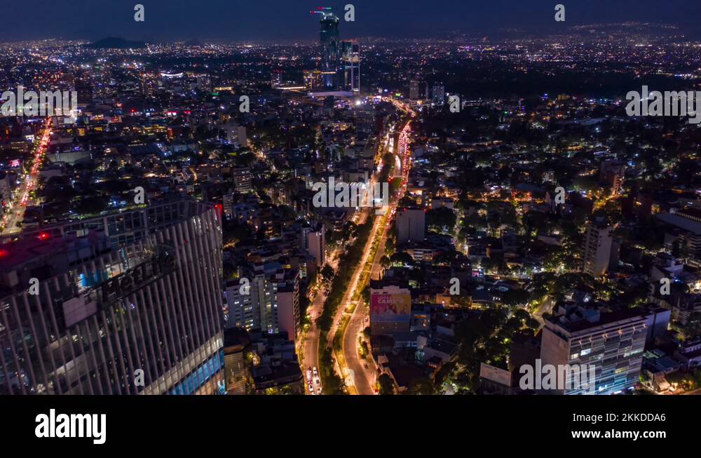 Aerial flyover of Manacar Tower Roundabout at night Traffic in Mexico ...