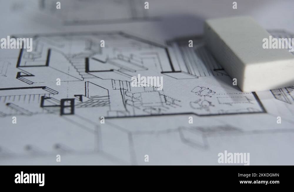 Man’s hand drawing lines on the house plan using pencil to make ...