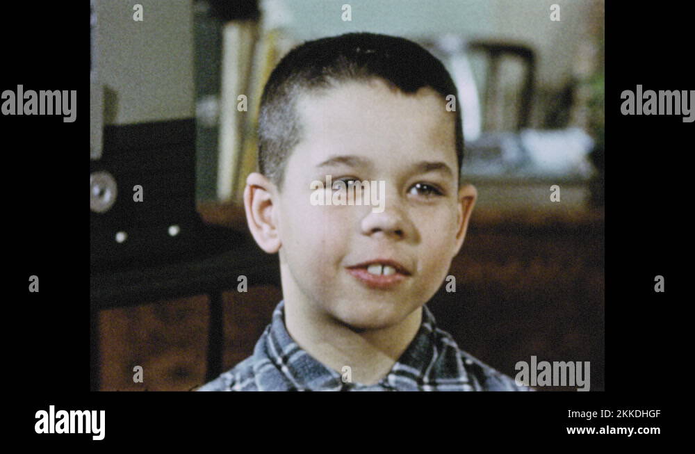 1950s: Boy in classroom talks. Teacher talks. Students in classroom ...