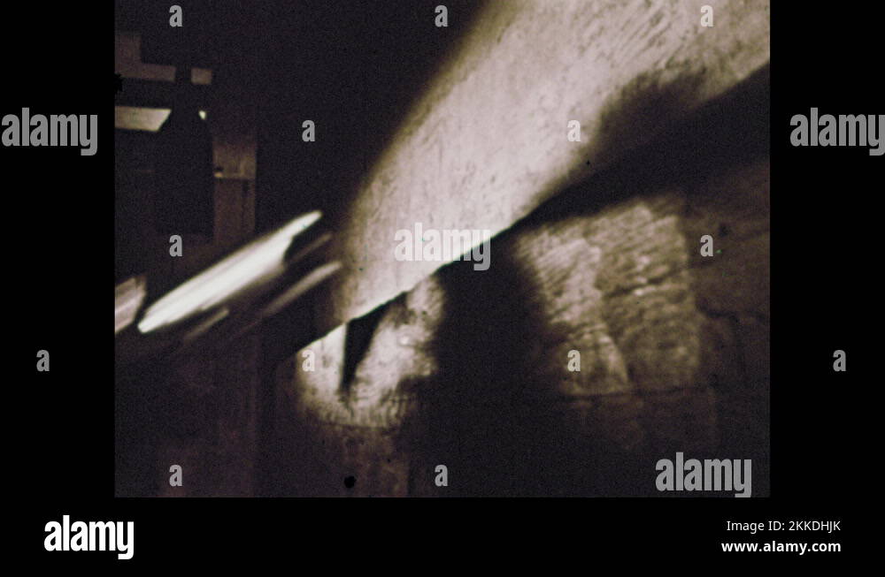 1950s: Rifle on wall. Person grabs rifle from wall. Person hits hot ...