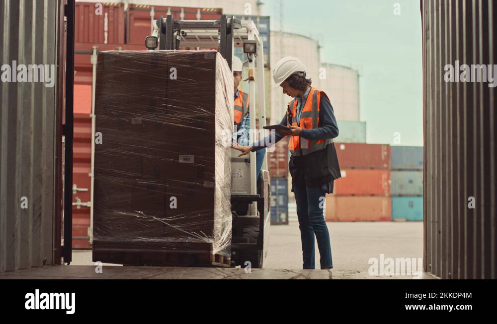 Worker and Forklift Driver Loading Container Stock Video Footage - Alamy