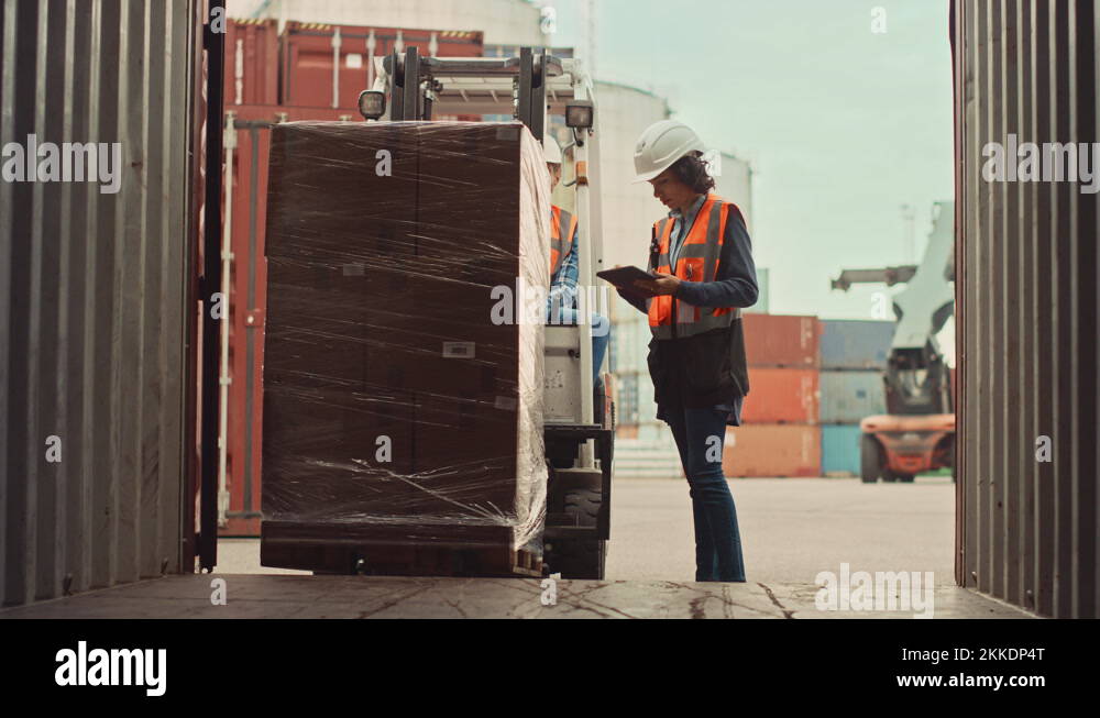 Worker and Forklift Driver Loading Container Stock Video Footage - Alamy