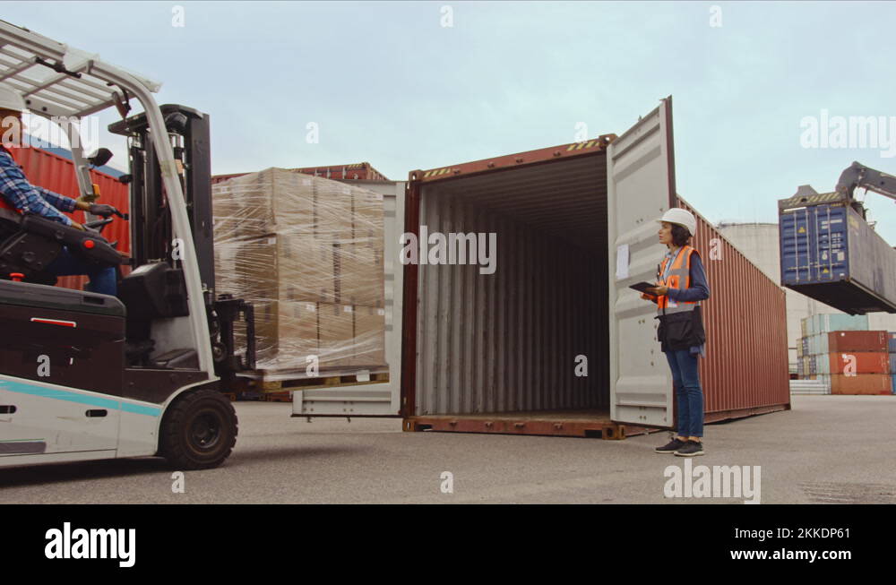 Worker and Forklift Driver Loading Container Stock Video Footage - Alamy