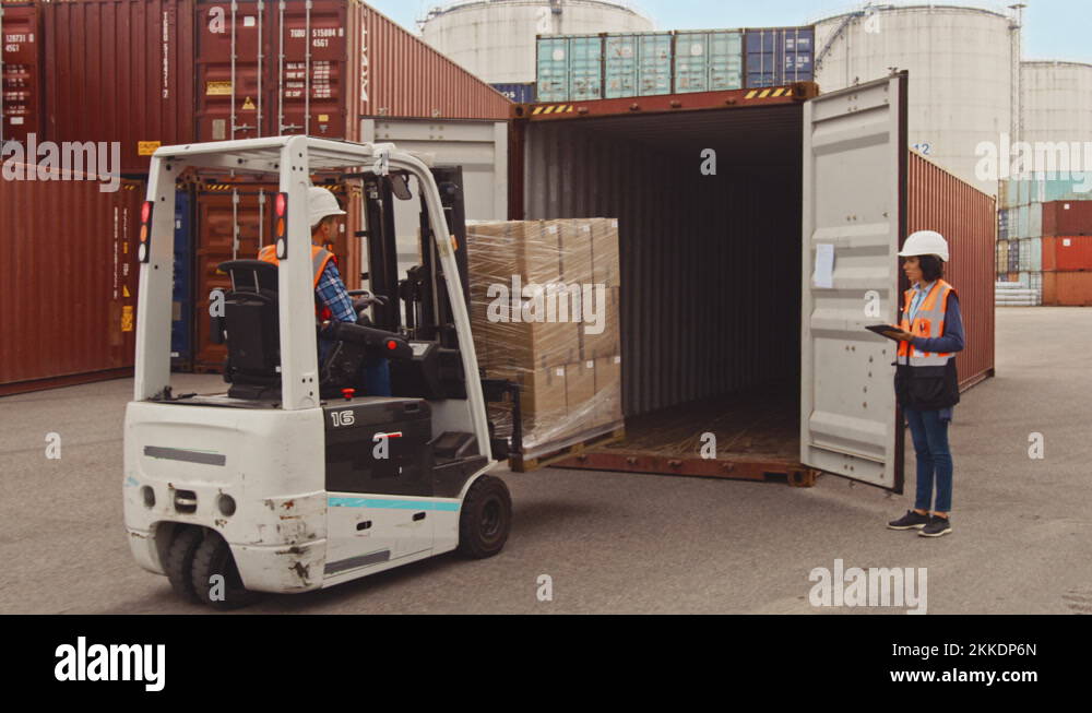 Worker and Forklift Driver Loading Container Stock Video Footage - Alamy