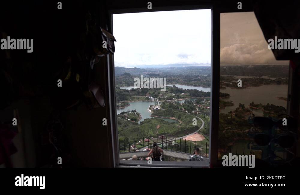 Cinematic shot through a window of Guatape green island, wide, travel ...