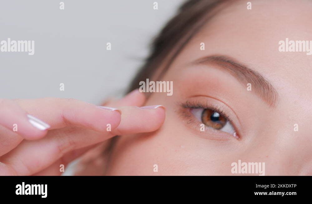 Woman touches her face, sliding from temple down to the chin Stock ...