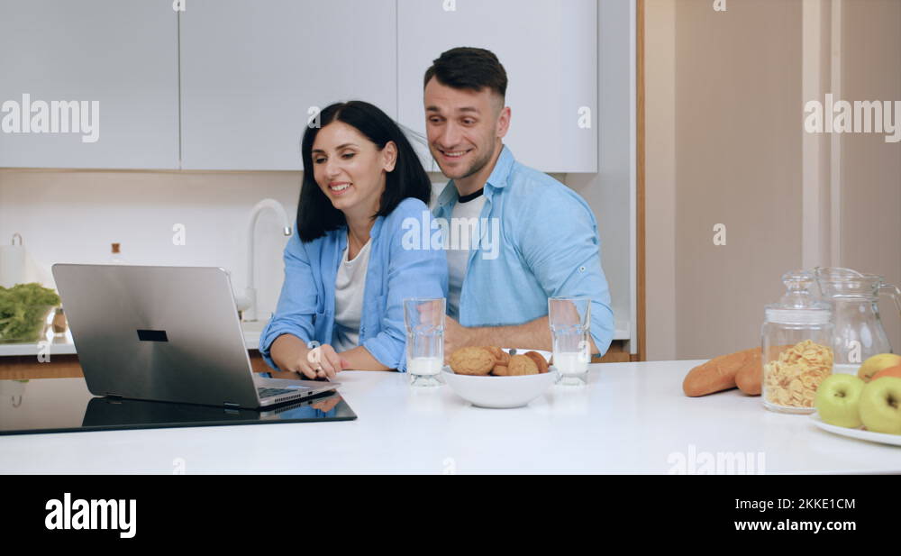 Attractive happy smiling married couple waving hands to say hello to ...