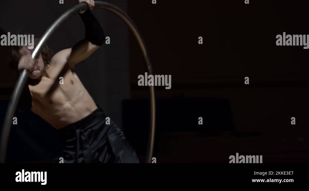 Gymnastics tricks by a young circus athlete, spinning in a wheel, 4k ...