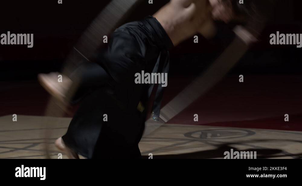 Circus performer is spinning in a massive metal wheel, gymnastics ...