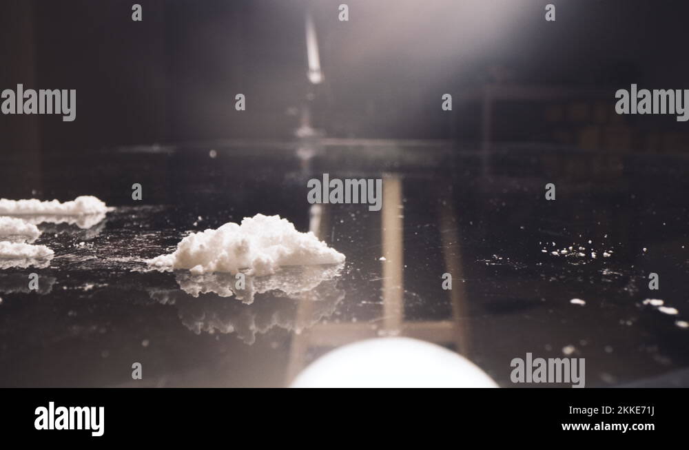 Cocaine junkie snorting line of coke with rolled US dollar bill. Drug ...