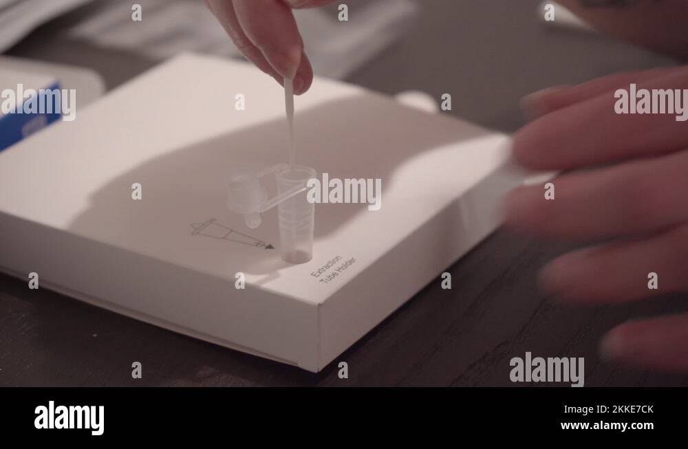 Girl inserts swab into pipette as part of the NHS Covid-19 self-testing ...