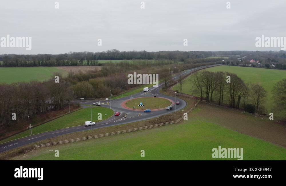 Drone moving away from a British roundabout in the countryside. Kent ...
