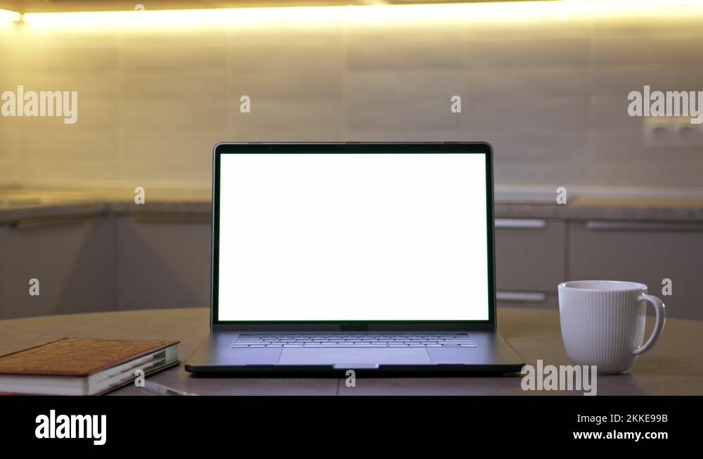 Mock-up desktop layout, computer with white screen and cup of coffee on ...