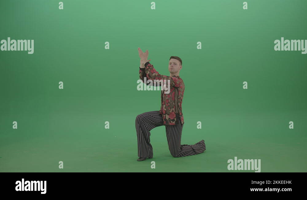 Rumba Man get down on one knees and clapping in hands over green screen ...