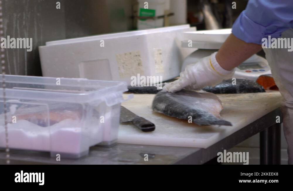 Slowmotion Chef preparing fresh salmon. Merchant sale seafood in fish ...