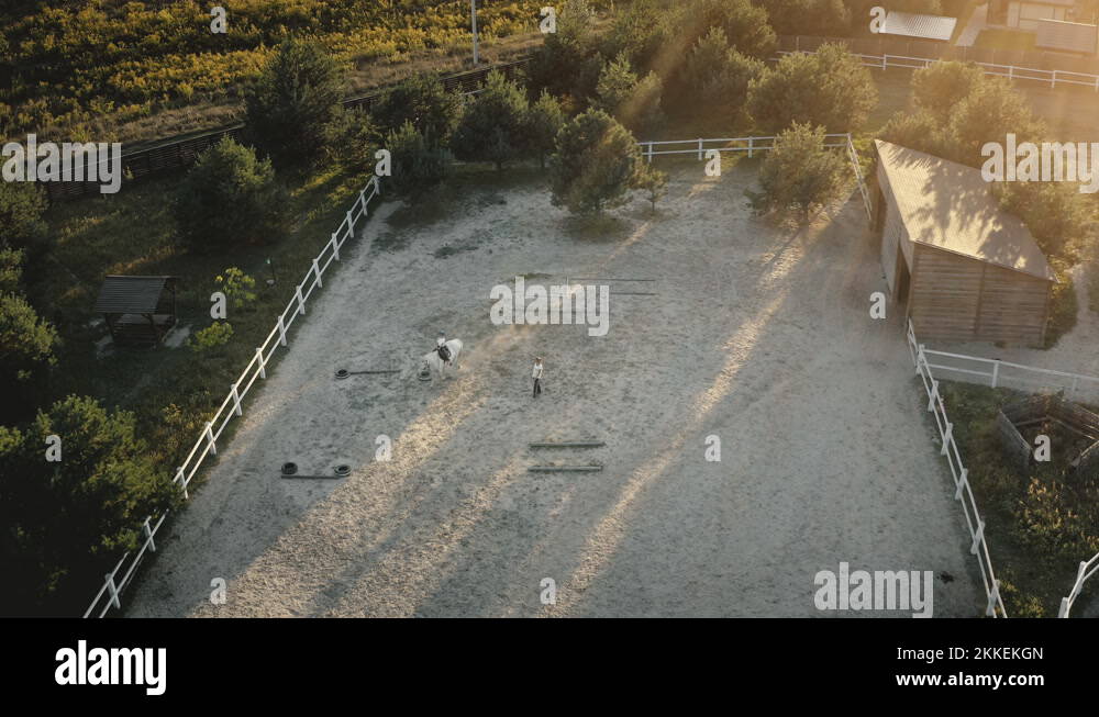 Horse run with rider on horseback aerial. Sun racecourse with farm ...