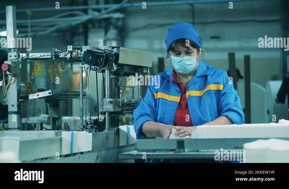 Female paper factory worker placing and sorting facial tissues Stock ...