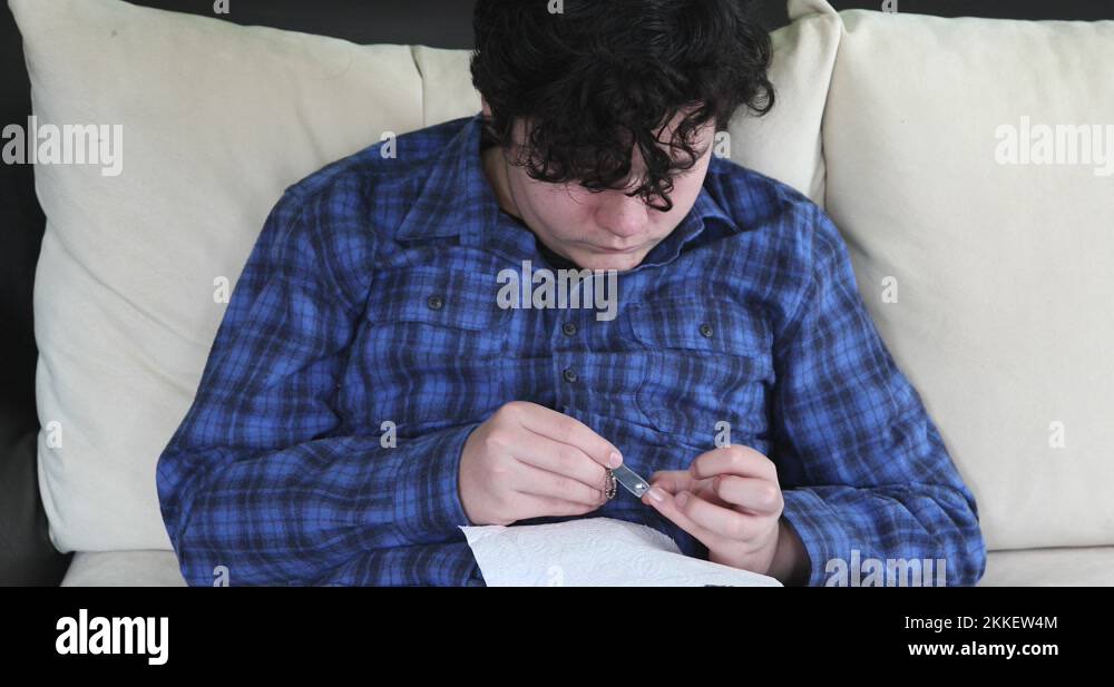 Young boy cutting nails using nail clipper Stock Video Footage - Alamy