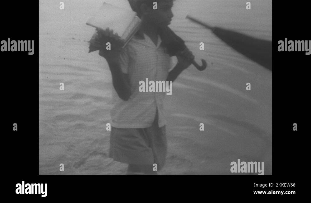 1960s: Flooding in India with flooded streets. People wade up to their ...