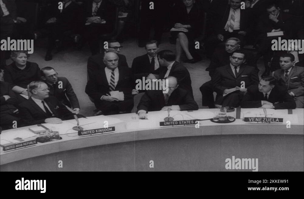 1960s: Politicians sit around table at the United Nations. Man speaks ...