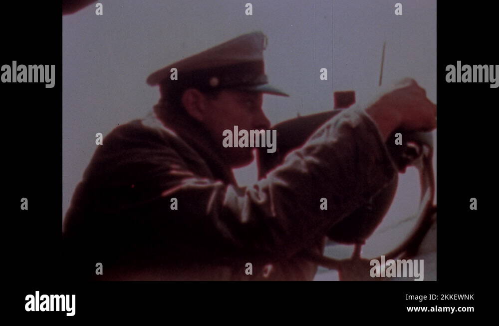 1940s: Ship, men walk on upper decks. Captain leans on scope, talks ...