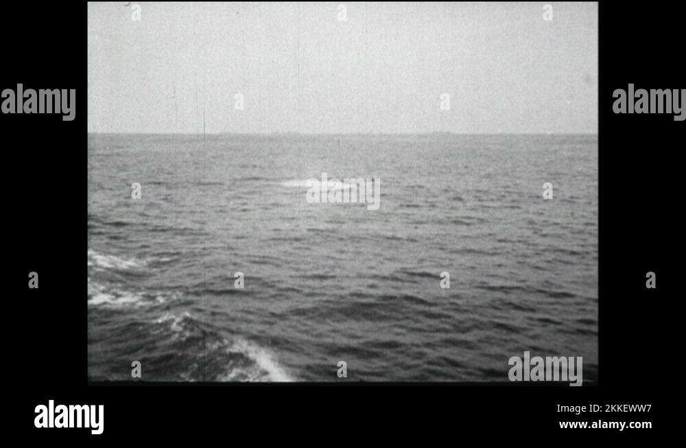 1940s: Water sprays into air from underwater explosions. Ship. Blimp ...