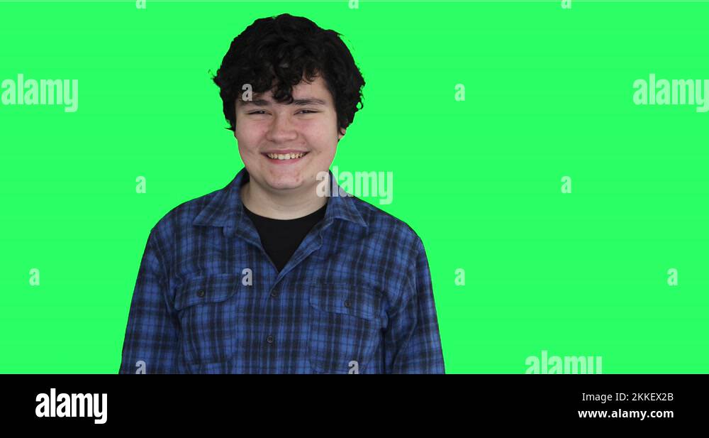 Smiling teenage boy with green screen background 1 Stock Video Footage ...