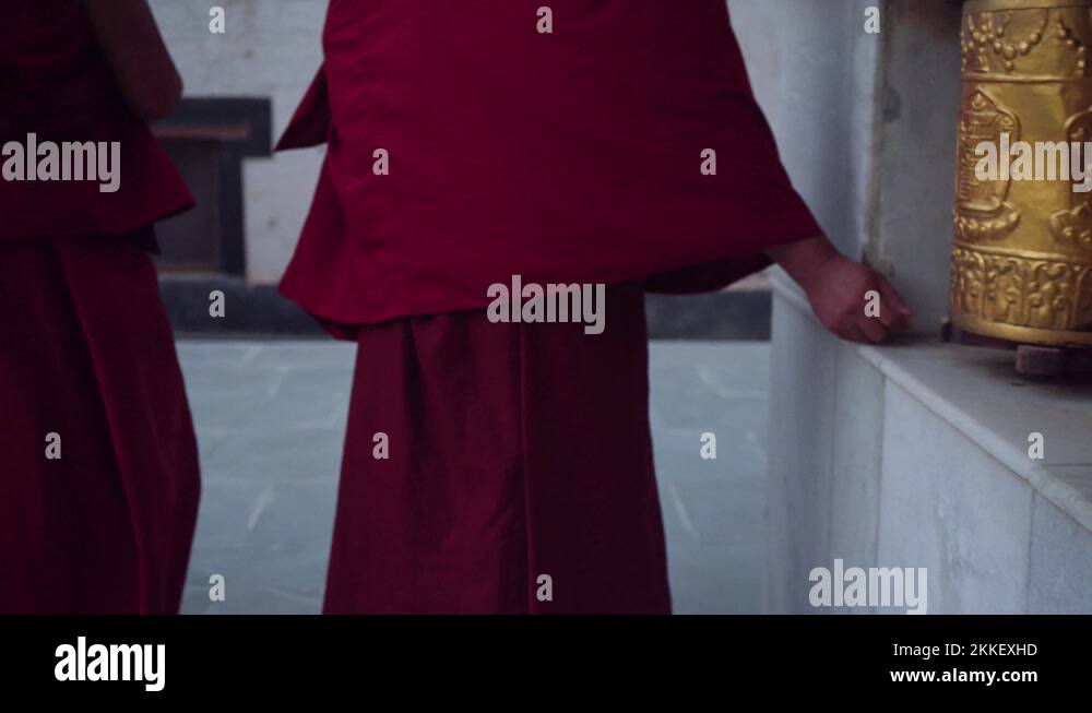 Monk Walking Around The Ancient Stupa And Spinning The Prayer Wheels In ...